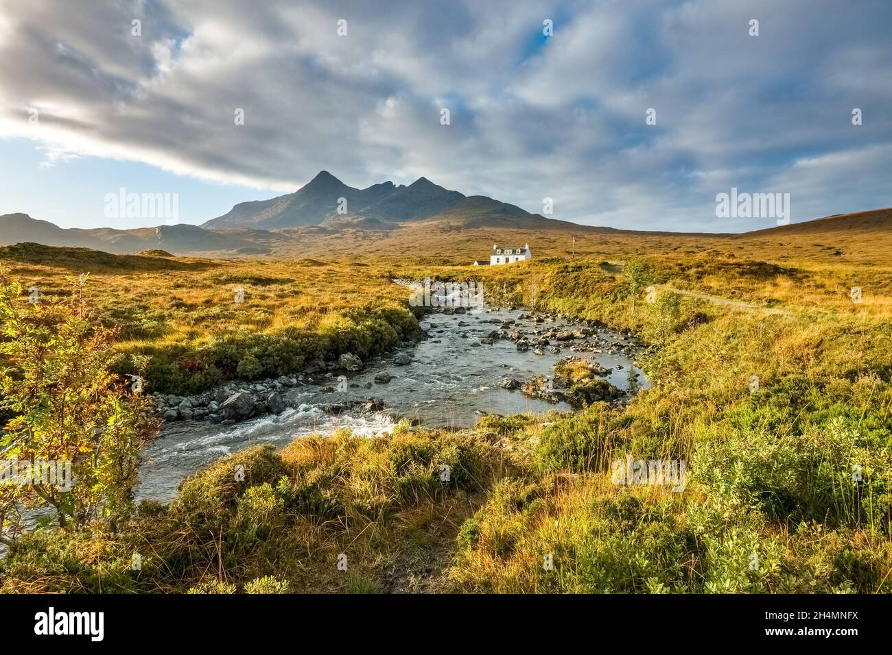 Isolated white cottage (Allt Dearg House) in Glen Sligachan with the ...