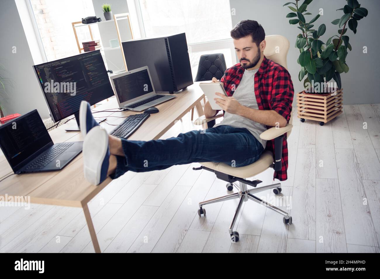 Full length photo of serious young man sit desk write notebook ...