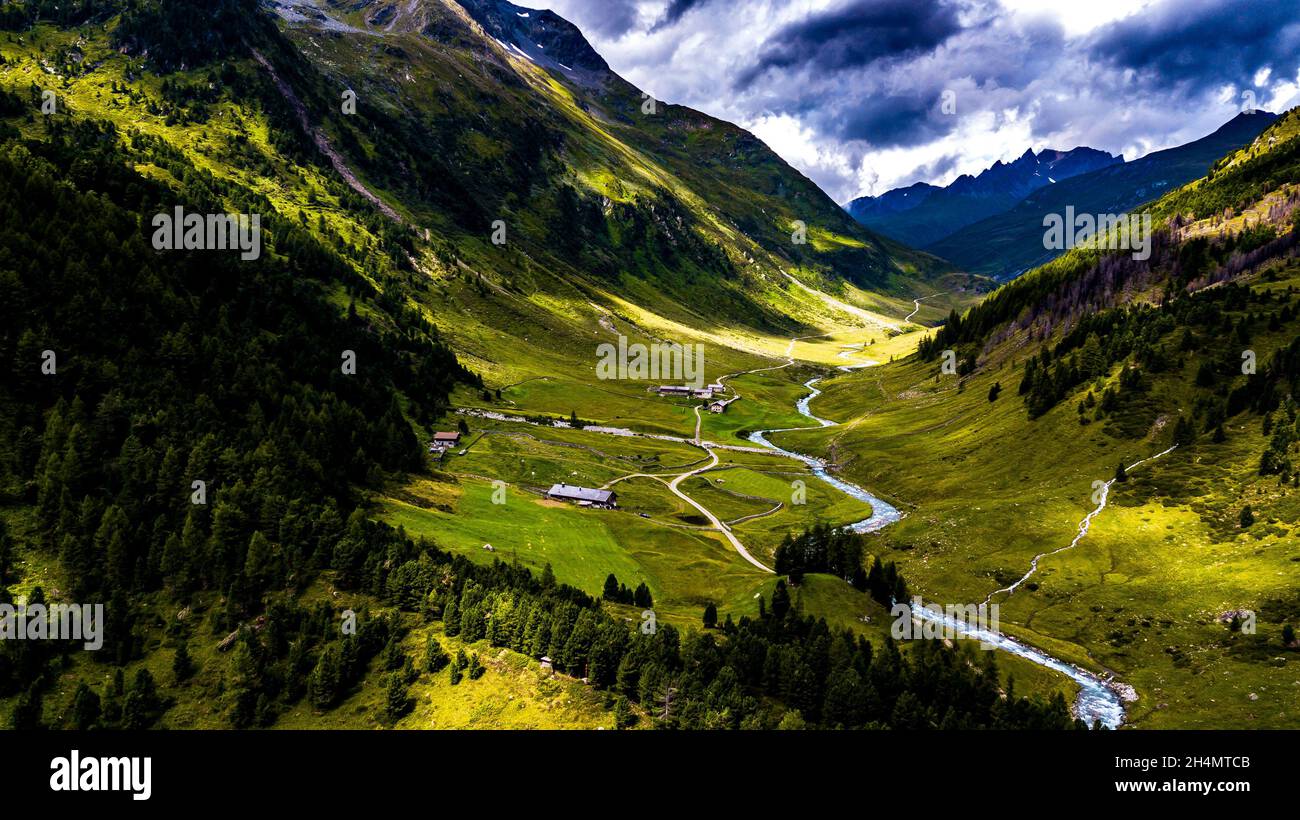 Remote Settlement With Farm Houses In Valley With Mountain River In ...
