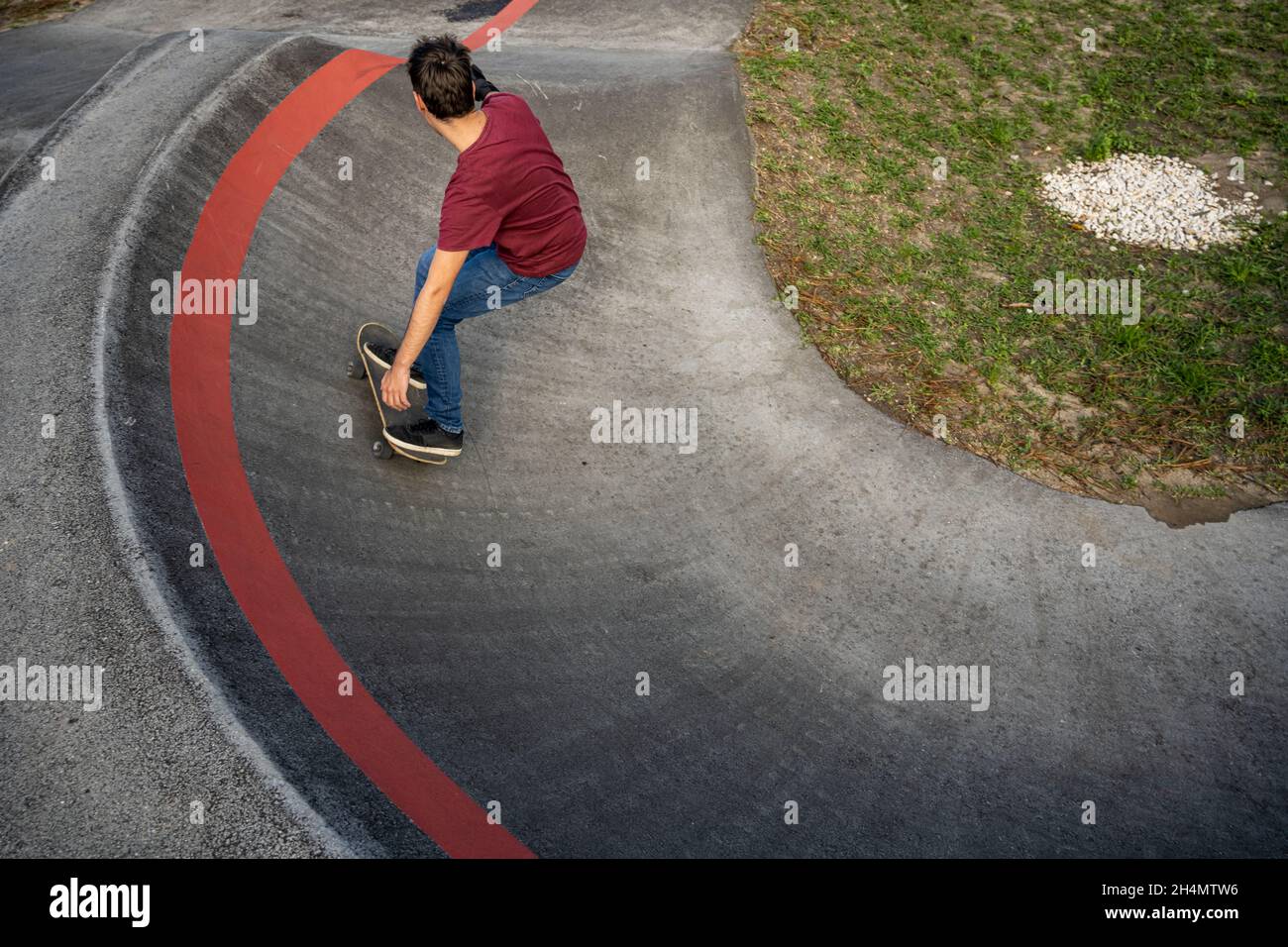 Skateboarder practice on a pump track park on a sunny day Stock Photo ...