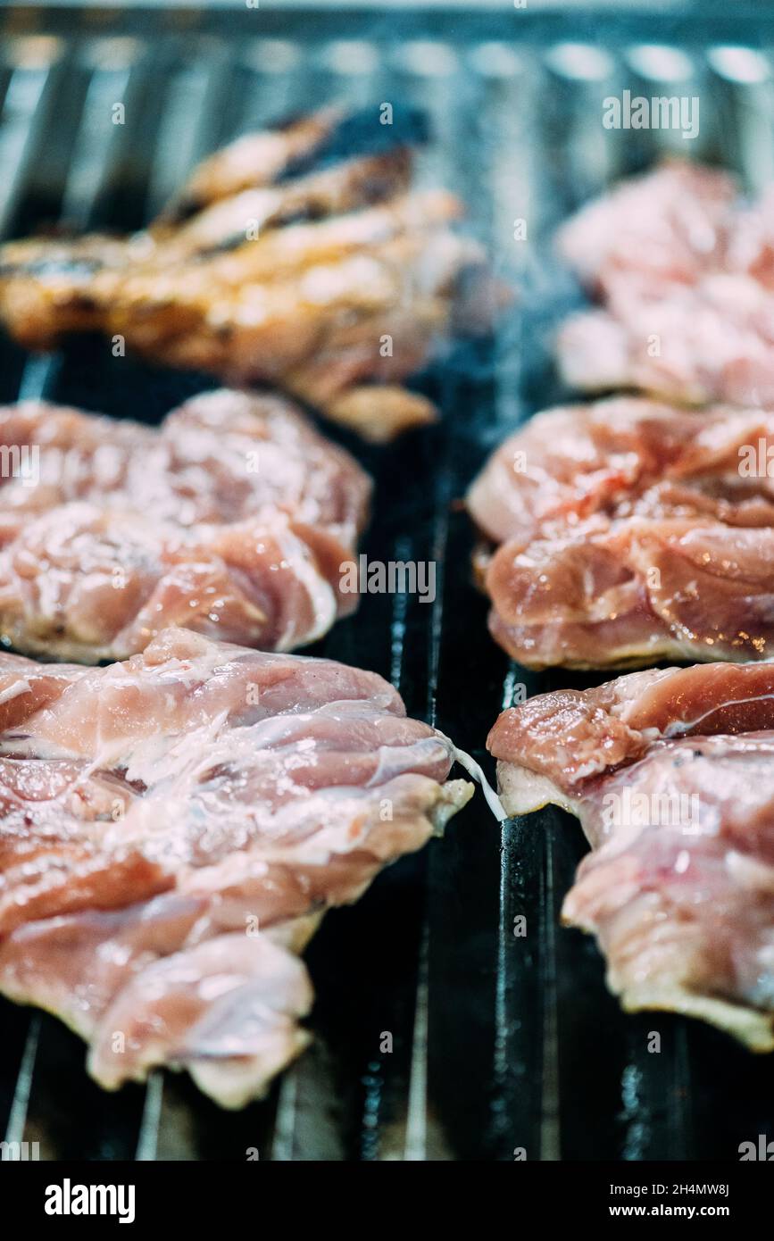 Vertical shot of meats being cooked on a grill Stock Photo - Alamy