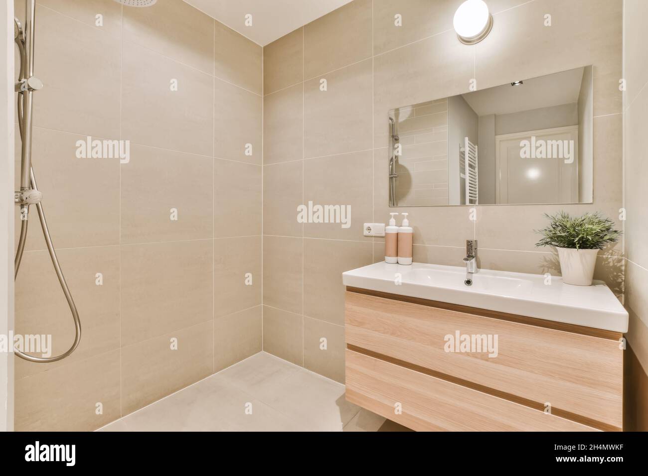 Beautiful image of a bathroom sink and shower area in a white interior ...