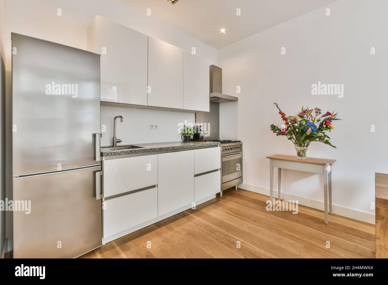 Beautiful image of a kitchen area in a white interior design house ...