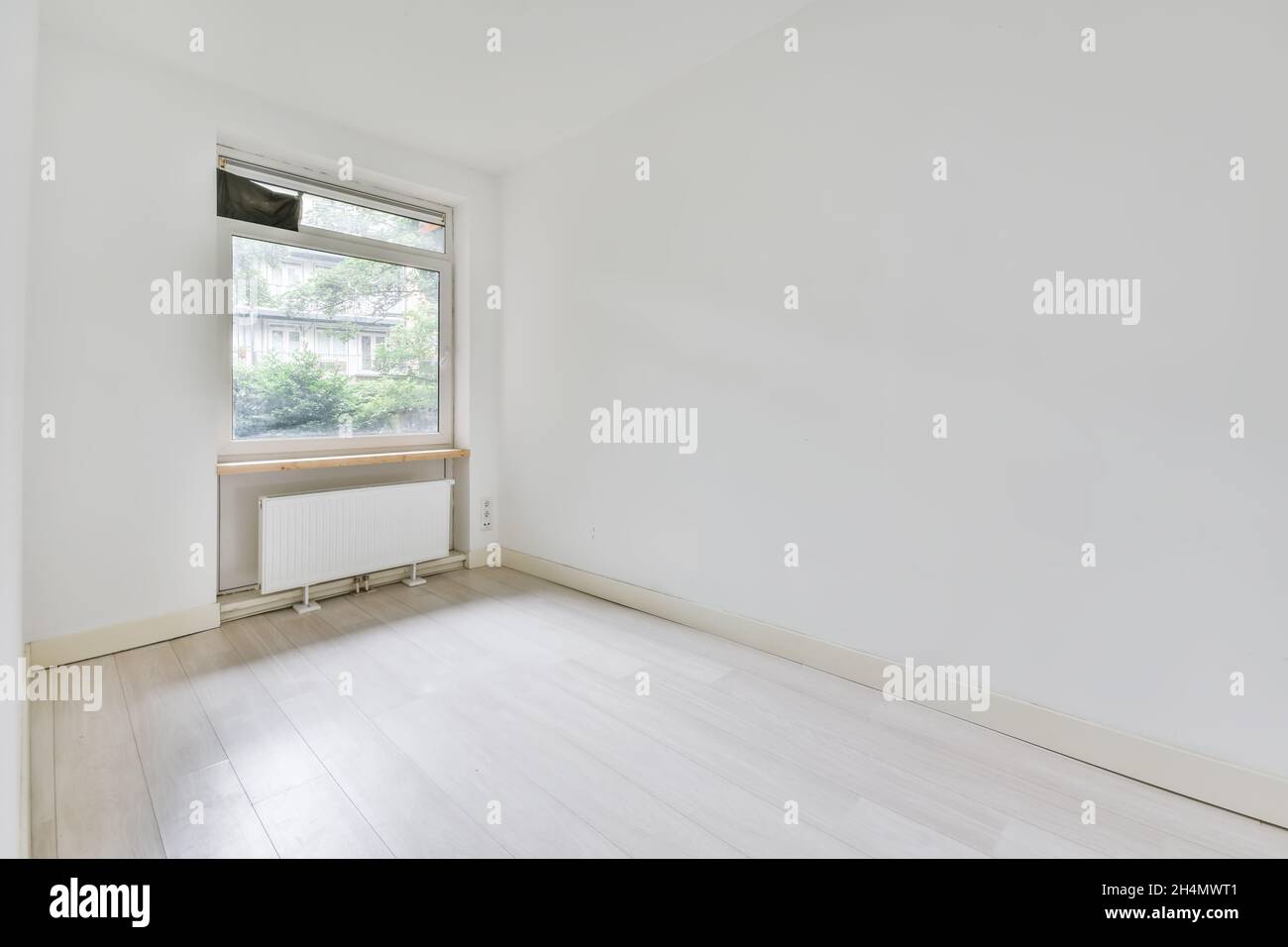 Beautiful image of an empty room with a heating radiator and window in ...