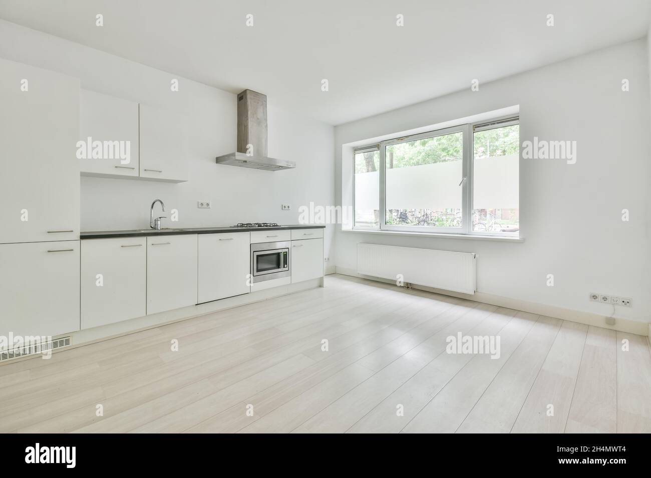 Beautiful image of an empty kitchen in a white interior design house ...