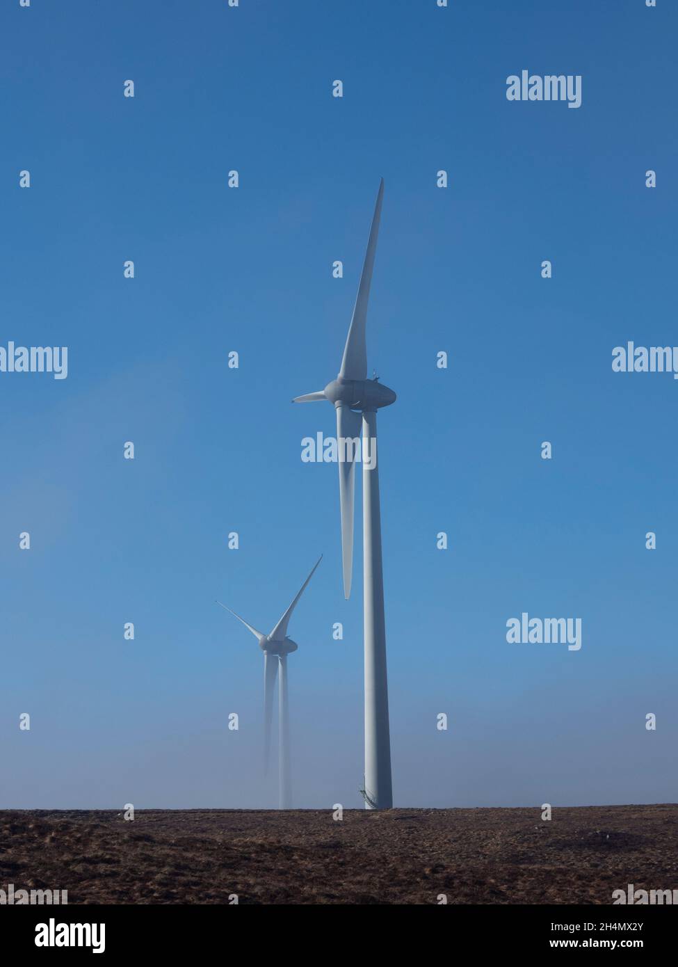 Wind turbines emerging from the mist. Corrimony Wind Farm, Highland ...