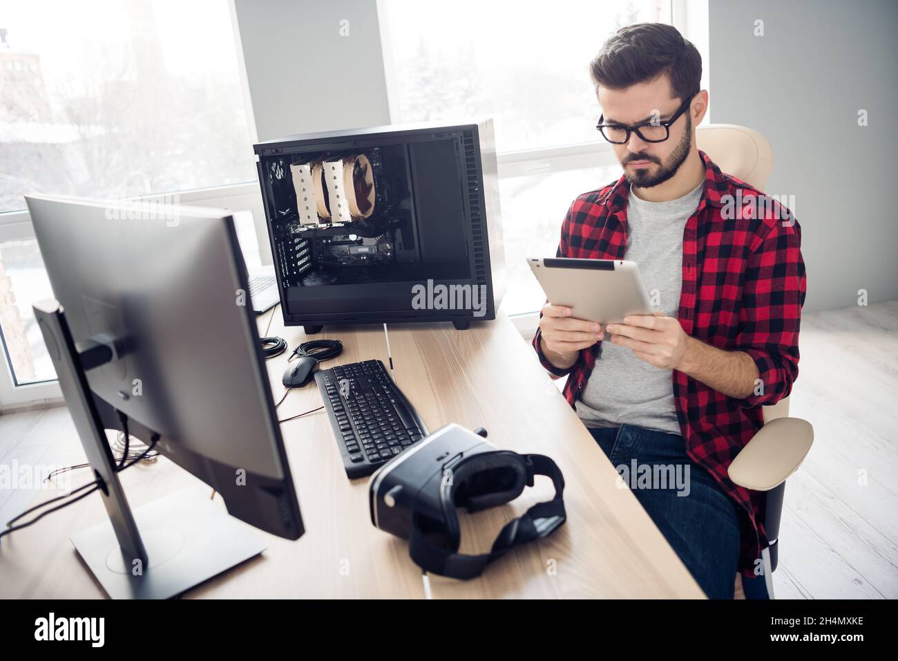 Portrait of attractive skilled trendy focused guy reading bug track ...