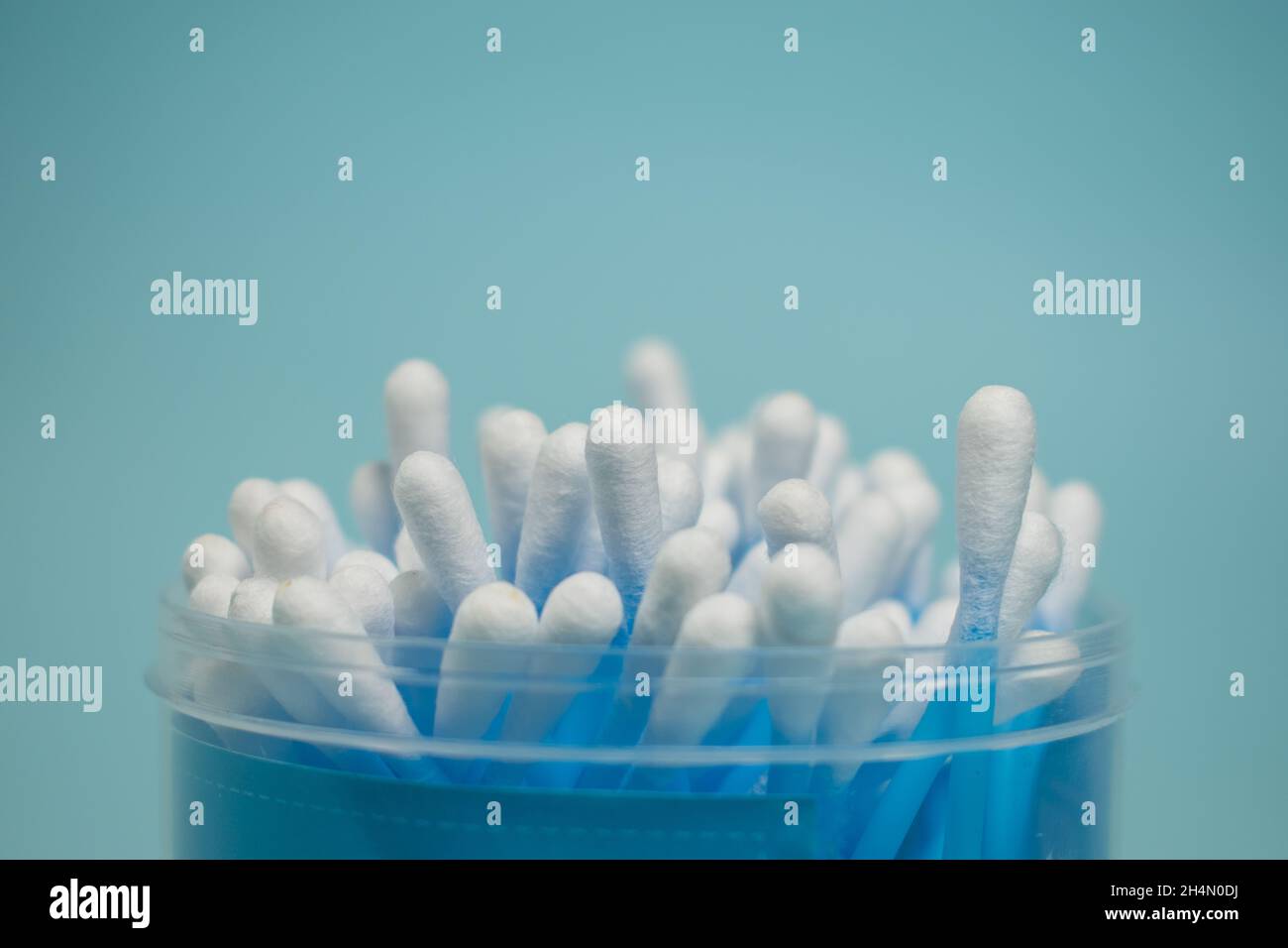 Blue cotton swabs with blue background Stock Photo - Alamy