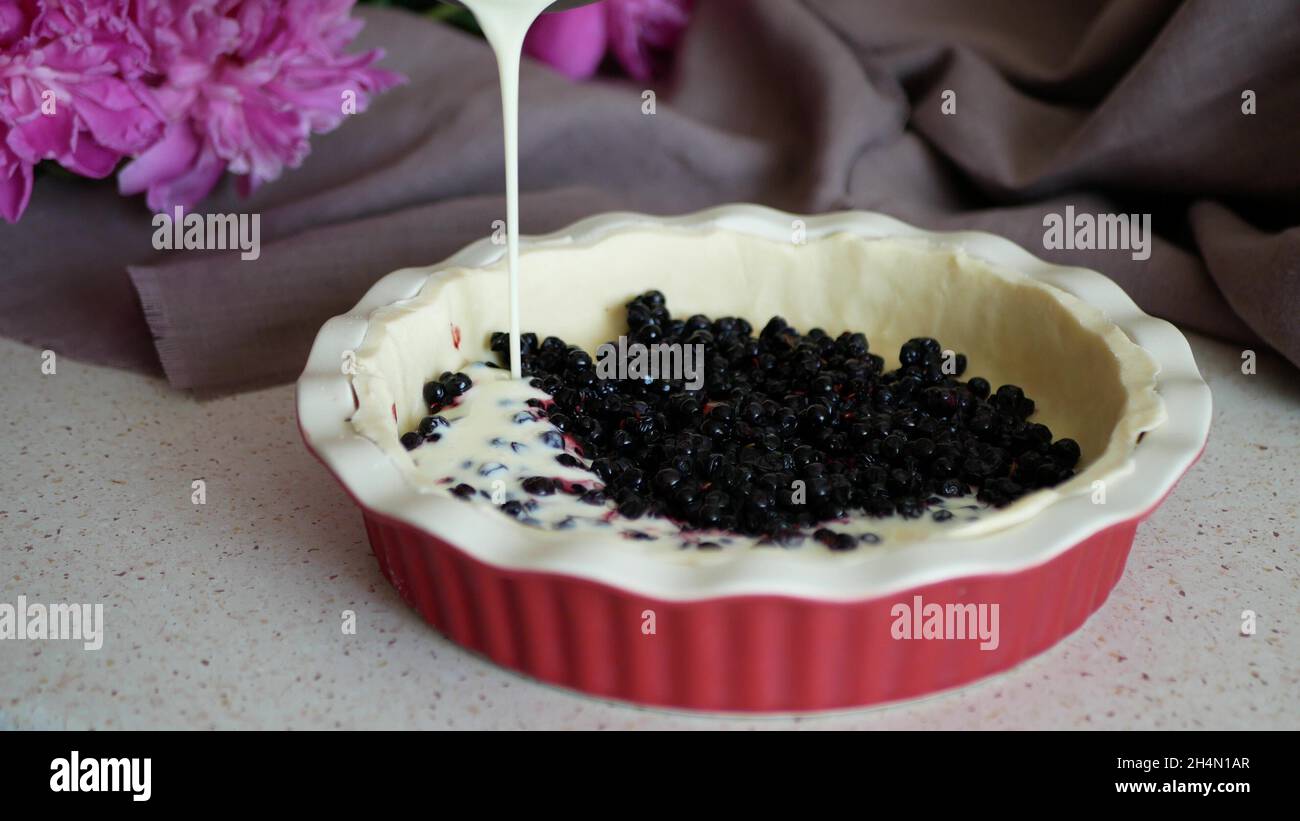 Pouring the filling over and around the berries. Cooking of the Finnish ...