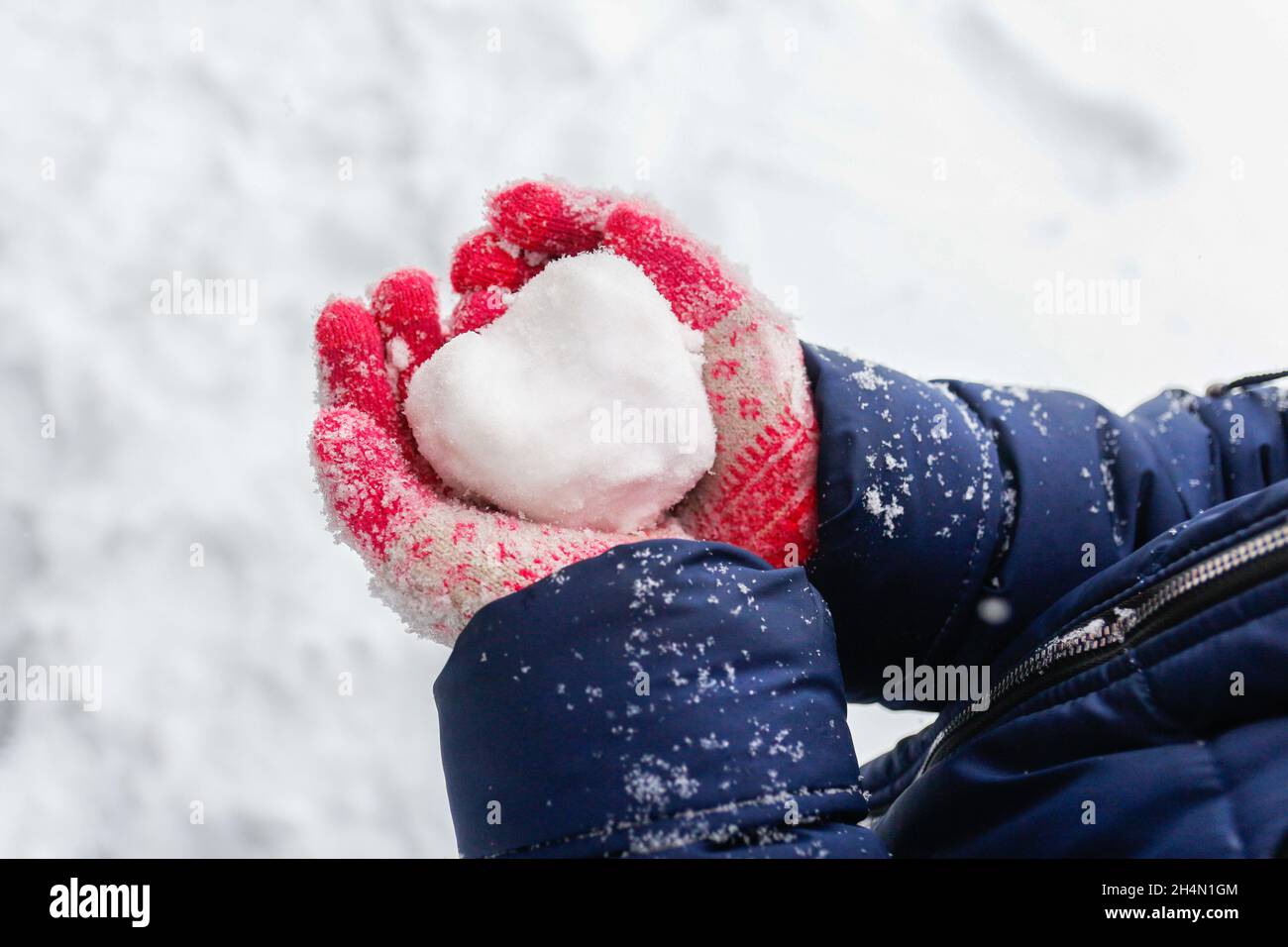 Child holding snowball hi-res stock photography and images - Alamy
