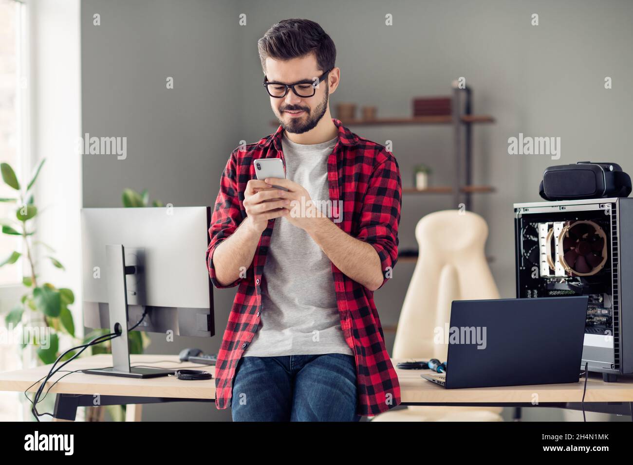 Portrait of attractive focused trendy guy using device gadget browsing ...
