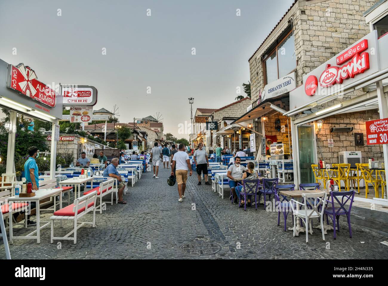 Alacati, Izmir, Turkey – October 3, 2020. A narrow paved street in ...