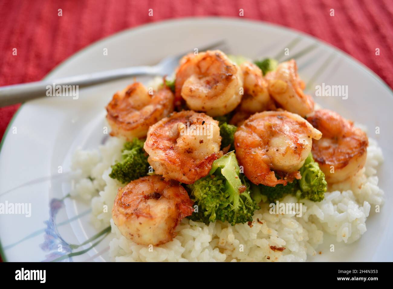 Famous North Shore garlic shrimp served over broccoli and rice on a ...