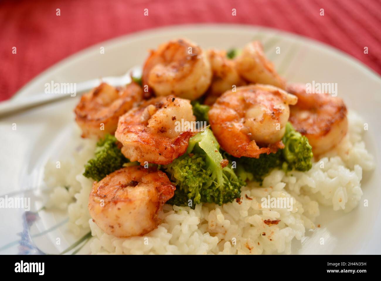 Famous North Shore garlic shrimp served over broccoli and rice on a ...