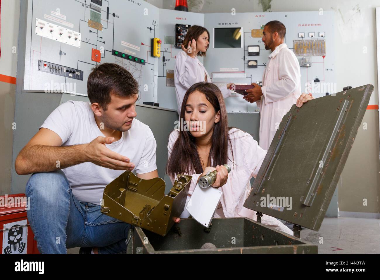 Young people with military box in lost room-bunker Stock Photo - Alamy