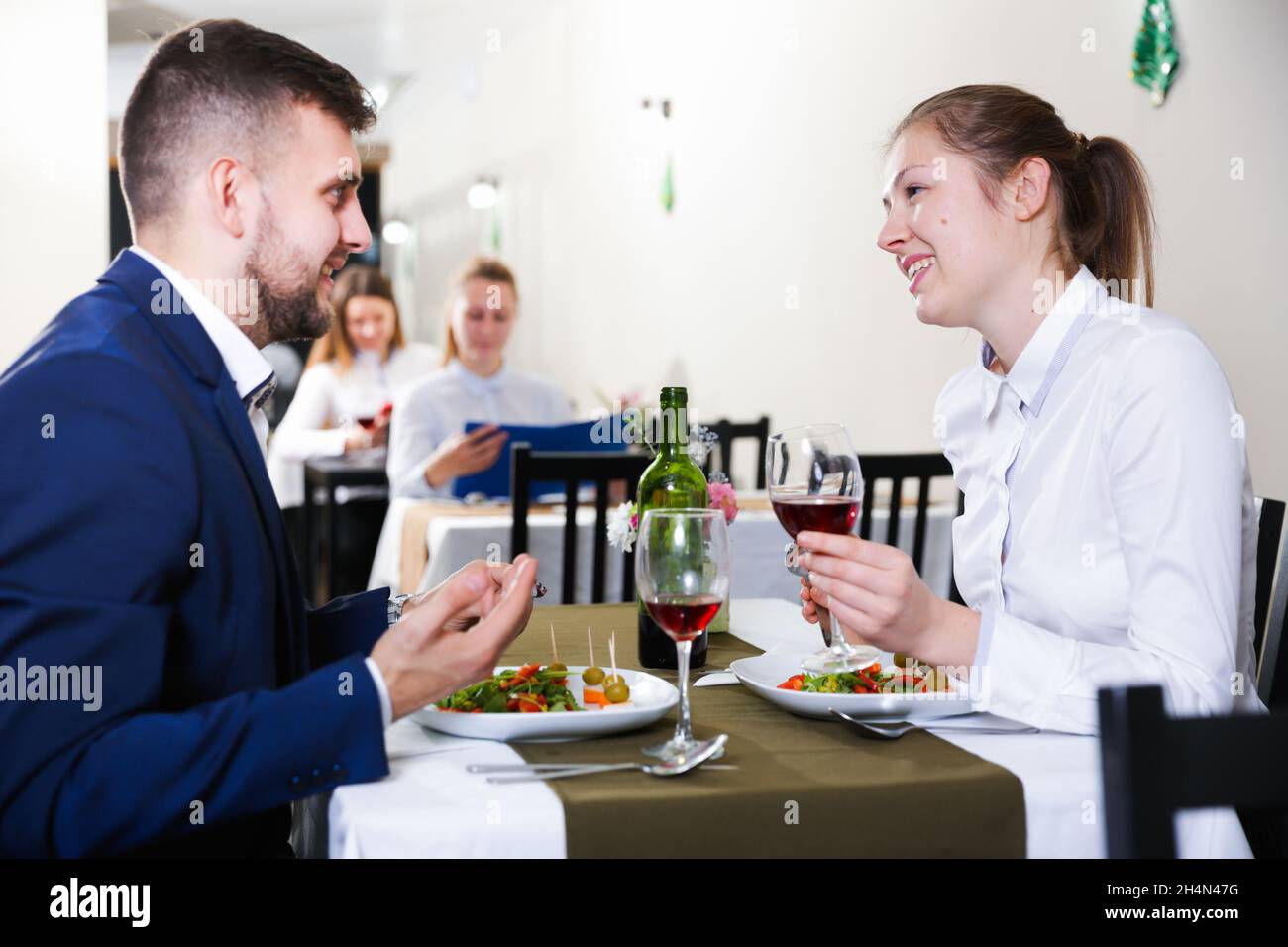 Gentleman with elegant woman are having dinner in luxury restaurante ...