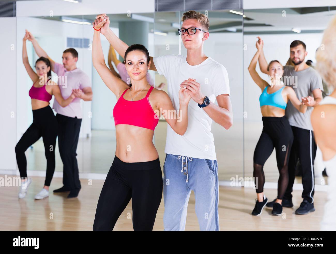 Dancing couples learning salsa at dance class Stock Photo - Alamy