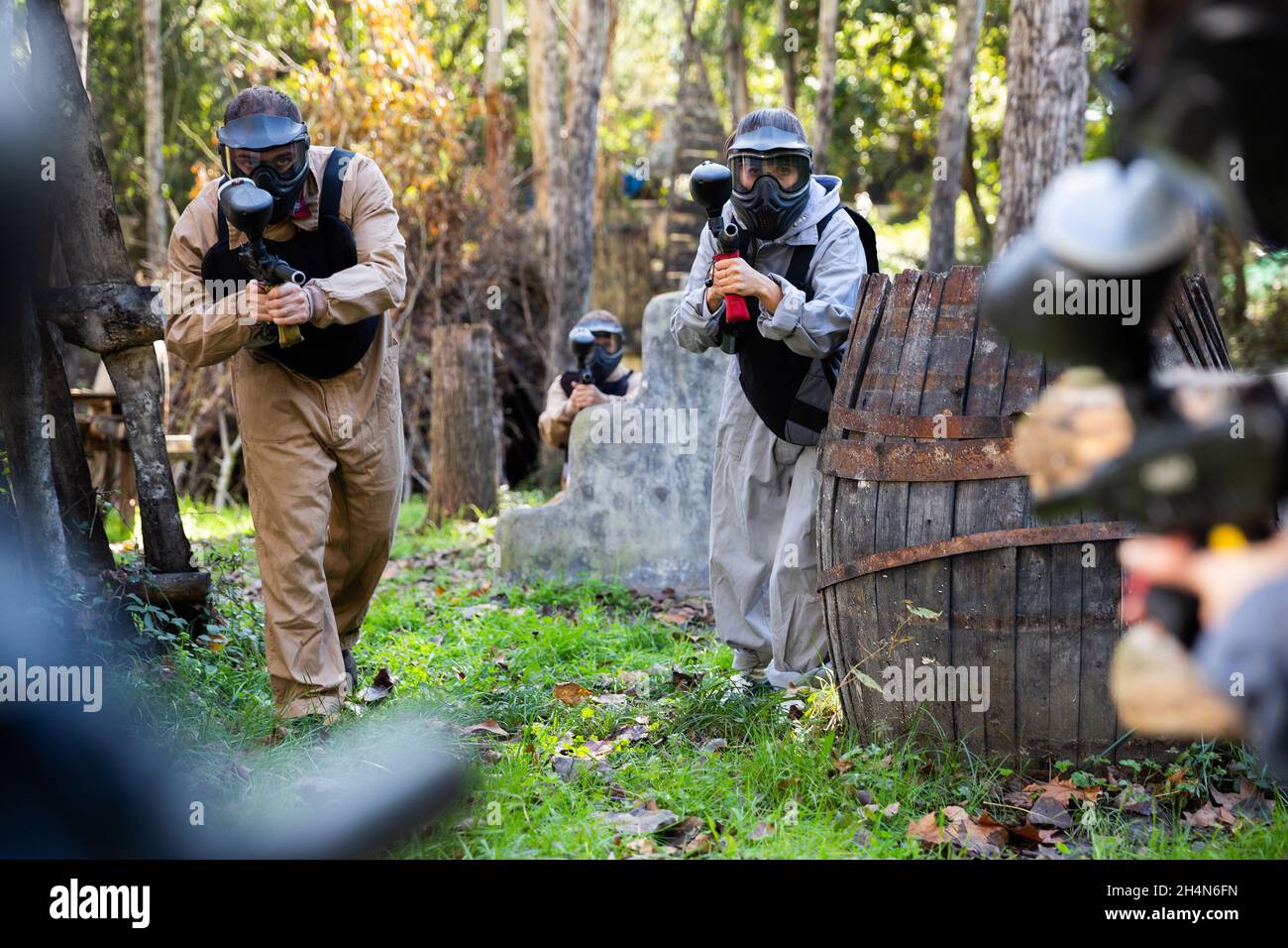 People playing paintball outdoors Stock Photo - Alamy