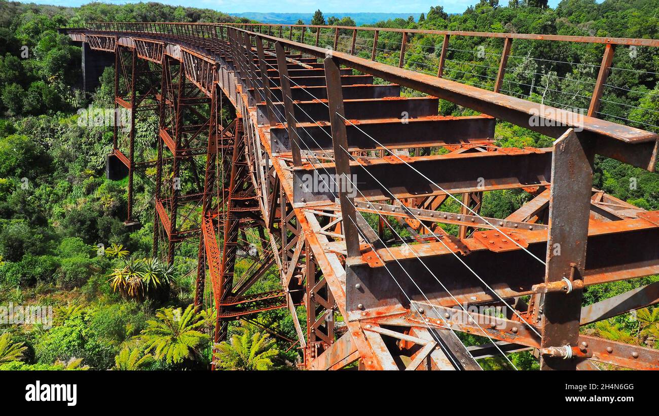 The Taonui viaduct, a disused and rusty railway bridge over a valley on ...