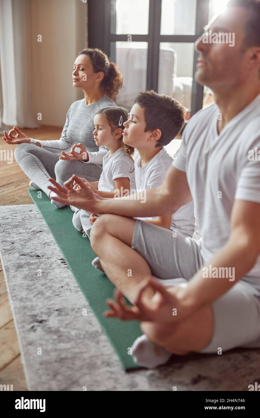 All family doing meditation together at home Stock Photo - Alamy