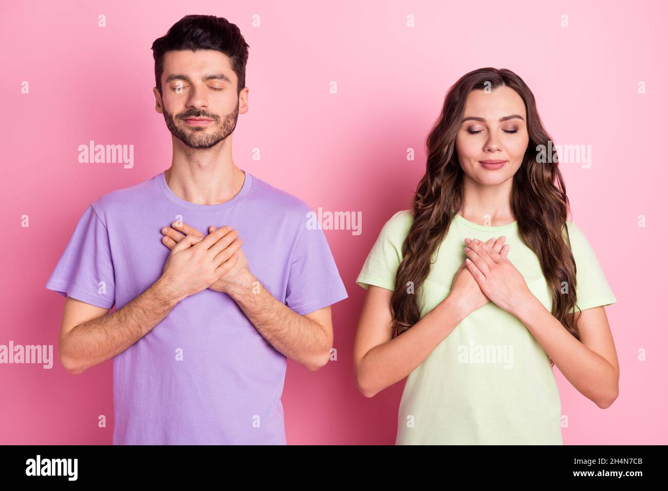 Portrait of attractive peaceful focused couple praying faith heart ...