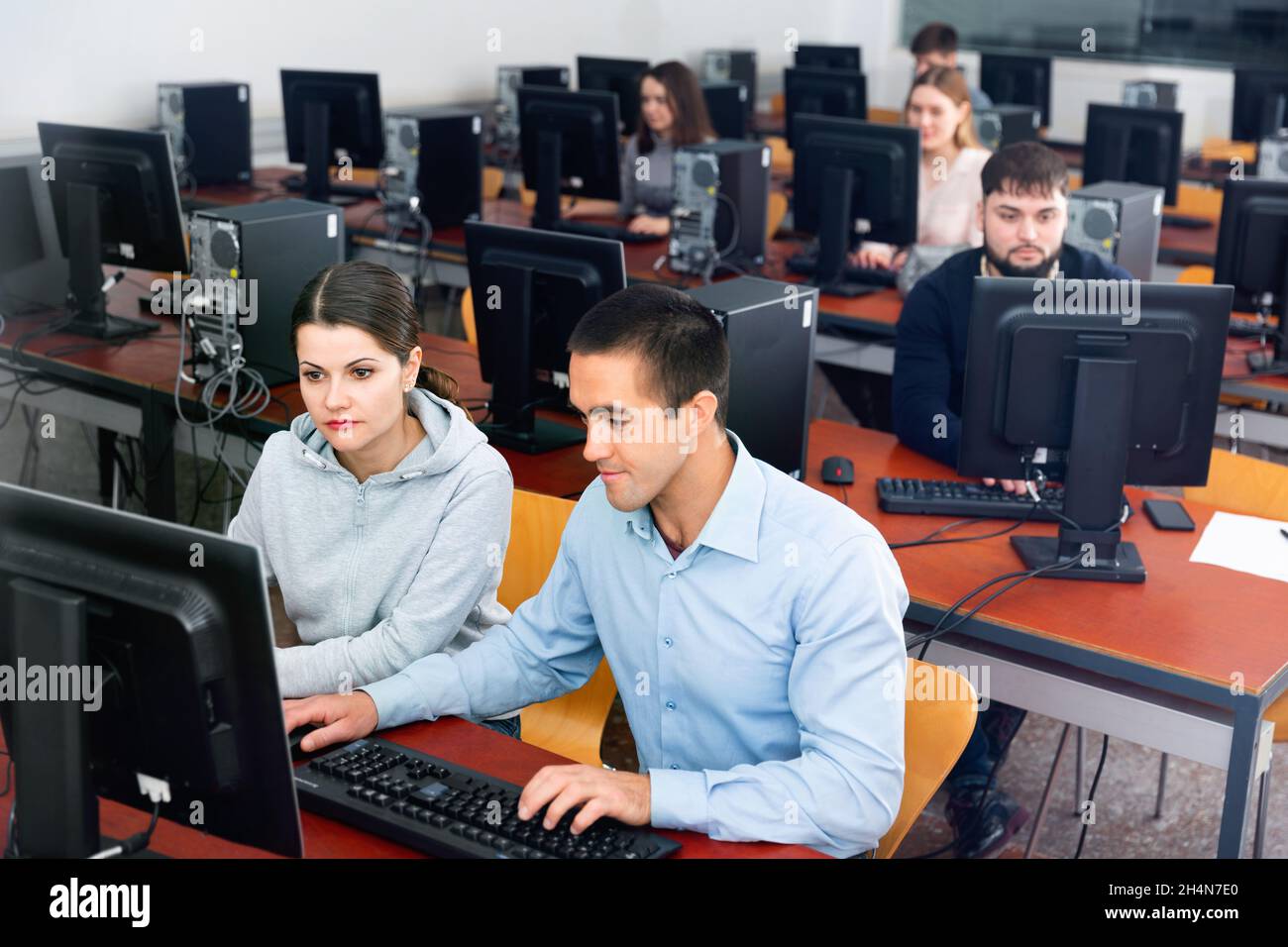 Computer Science Teacher Supervises The Execution Of A Programming Task In A Computer Class