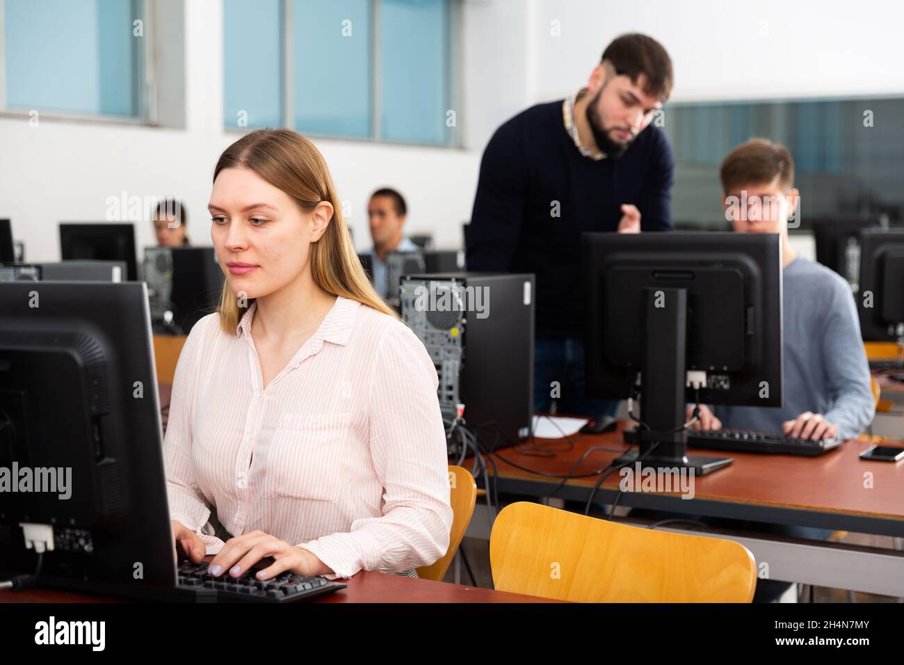 Teacher conducts computer science exam in university class Stock Photo ...
