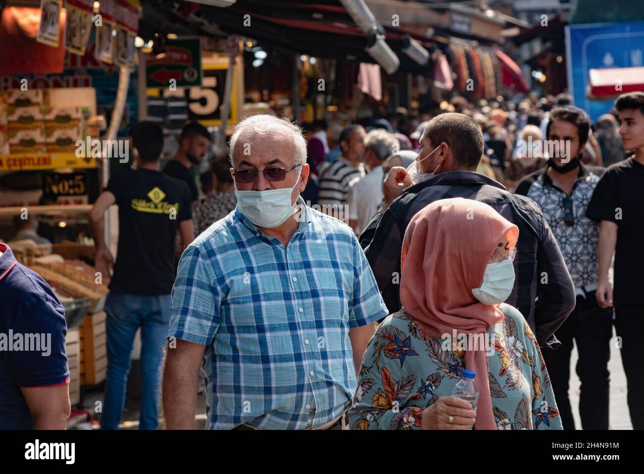 A Turkish couple seen wearing protective face masks in a busy market in ...