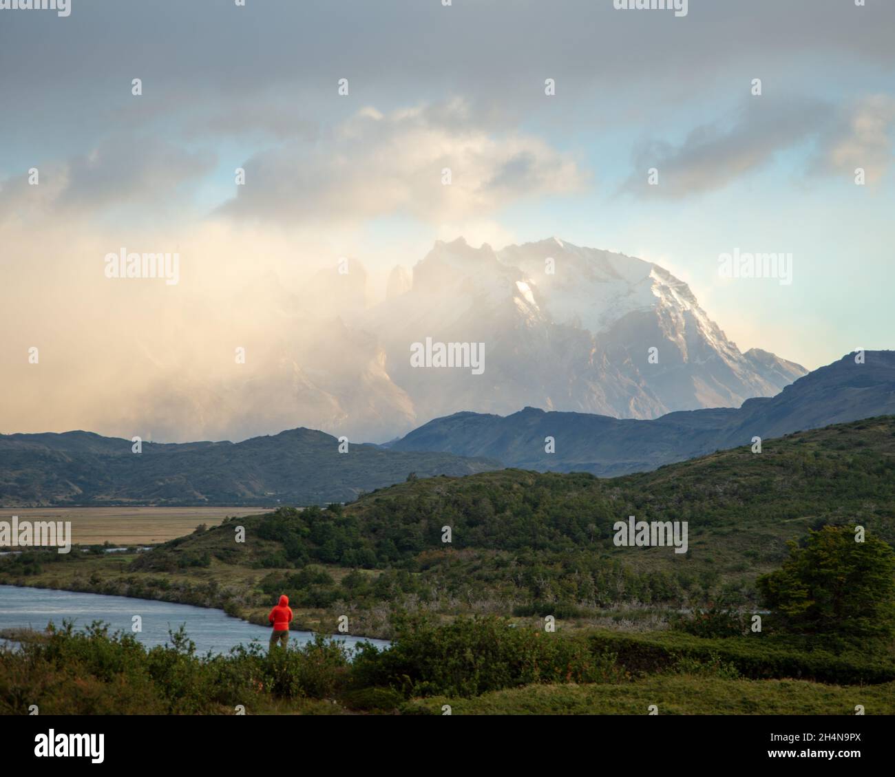 View of Mountains, grass meadow, and river during sunrise in Patagonia ...