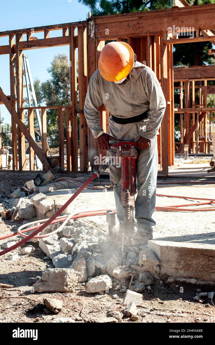 Construction worker using a jackhammer to remove a concrete slab Stock ...