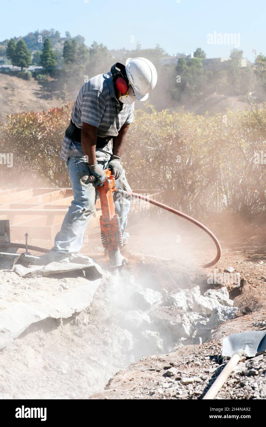 Construction worker using a jackhammer to remove a concrete slab Stock ...