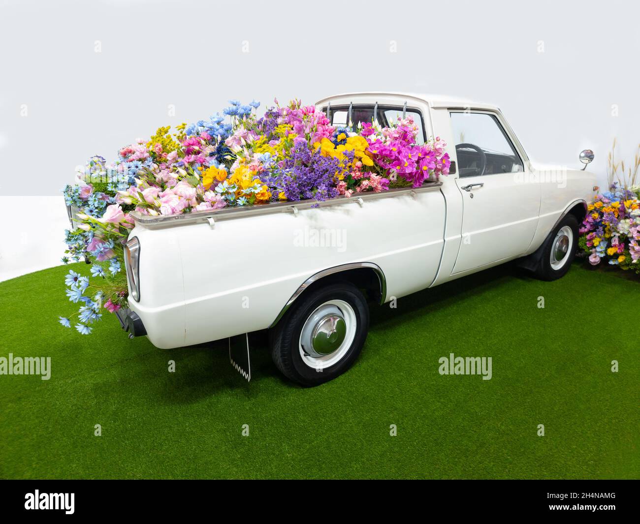 White old truck carrying load of flowers. Spring flowers bouquet Stock ...
