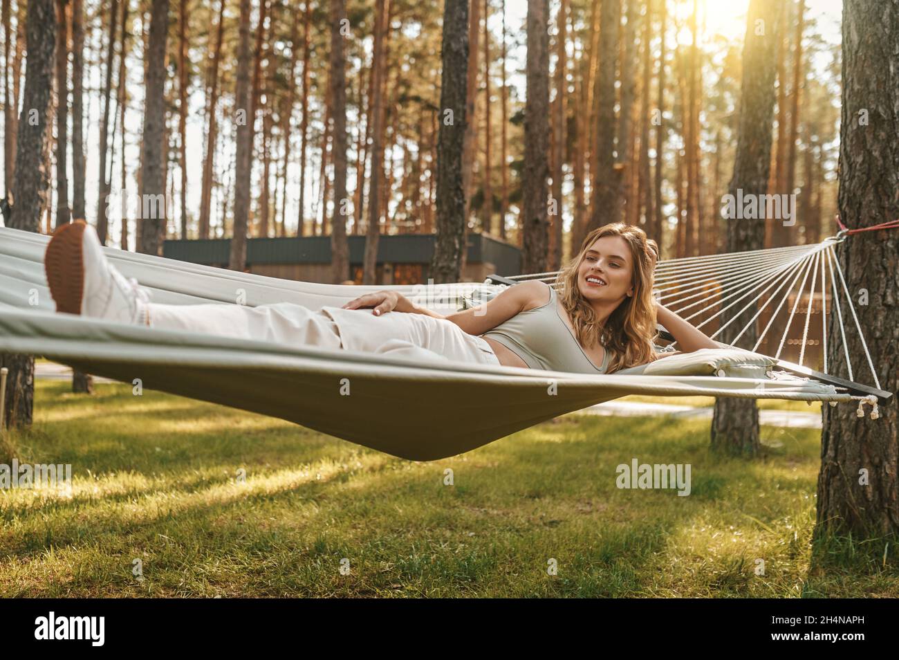 Woman in pensive mood relaxing on hammock Stock Photo - Alamy