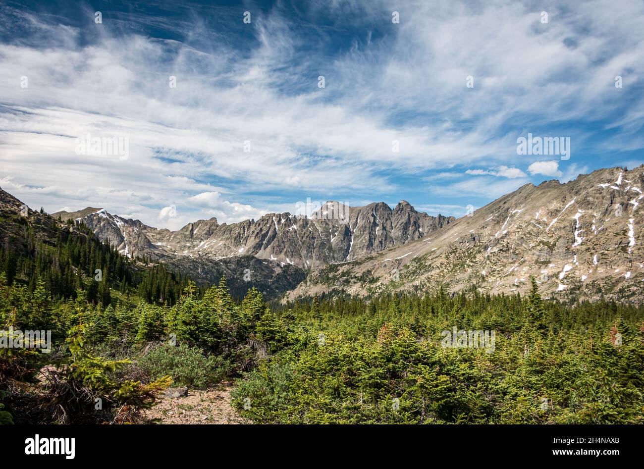 Rugged mountain ridgeline in the distance on a bright sunny day with ...