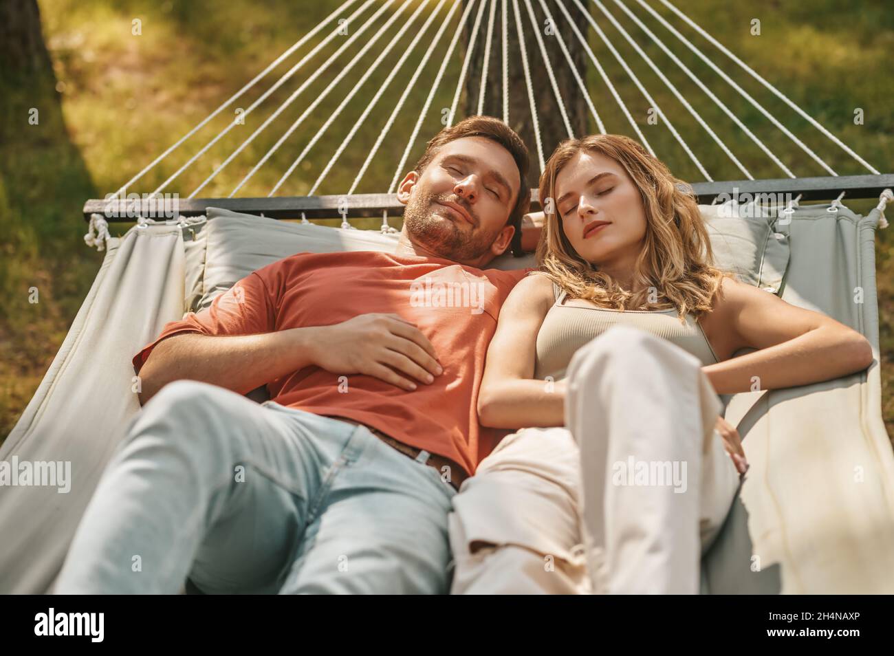 Young couple napping on hammock in nature Stock Photo - Alamy