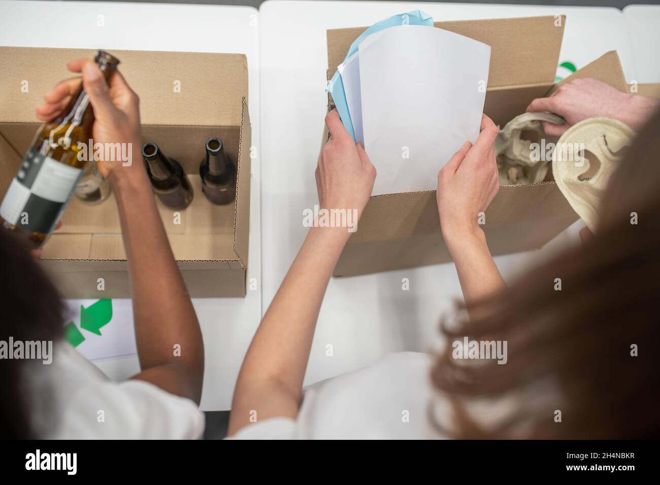 Close up picture of girls hands sorting the stuff in boxes Stock Photo ...