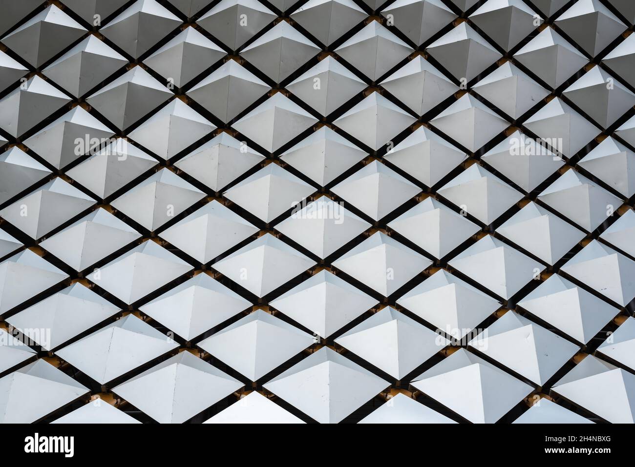Metallic structure with geometric shapes on a building roof close-up ...