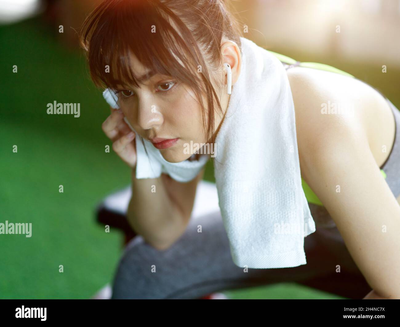 Exhausted fitness woman sweating after had a hard body weight training ...