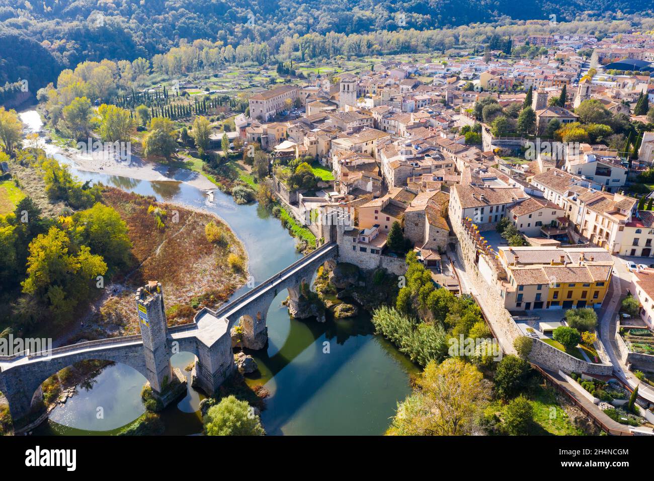 View from drone of Besalu with arched bridge over Fluvia river Stock ...