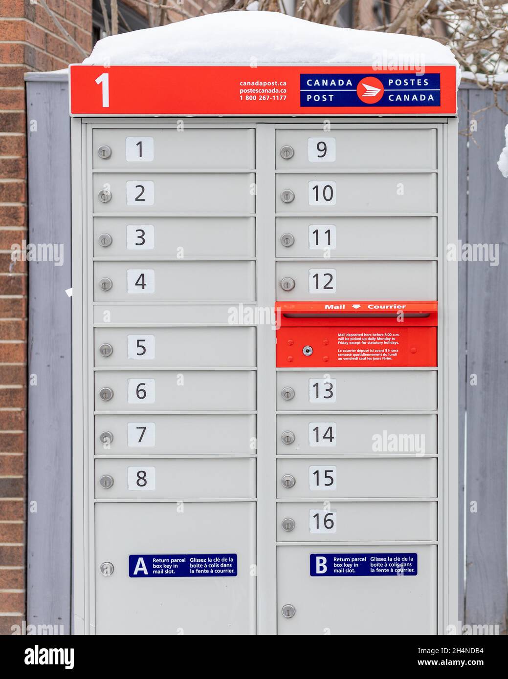 Canada Post mailboxes with red sign in English and French near house in ...