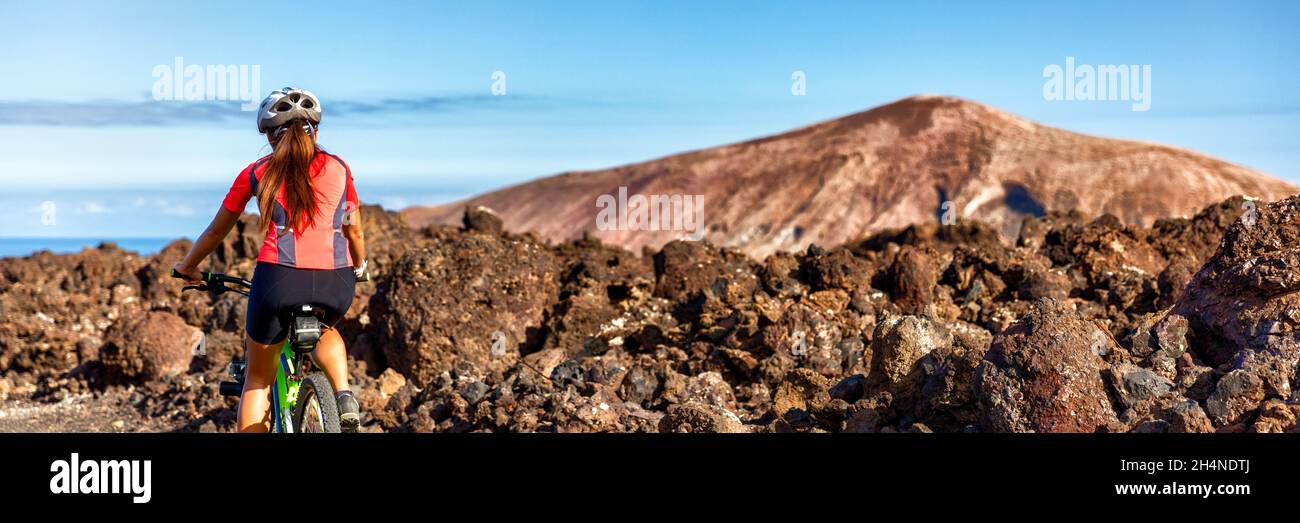 Mountain biking woman cyclist cycling in nature travel summer landscape ...