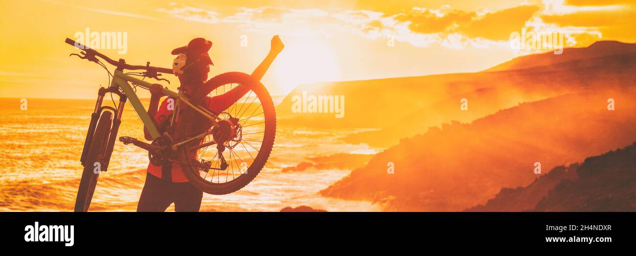 Mountain bike biking cyclist winning race with arms up in success ...