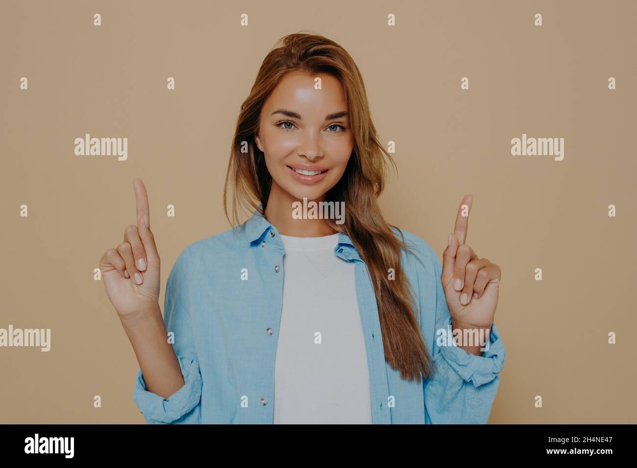 Charming female expressing happiness on beige background Stock Photo ...