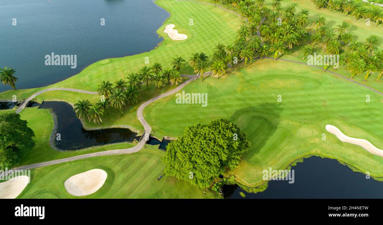 Aerial view drone shot of beautiful green golf field fairway and ...