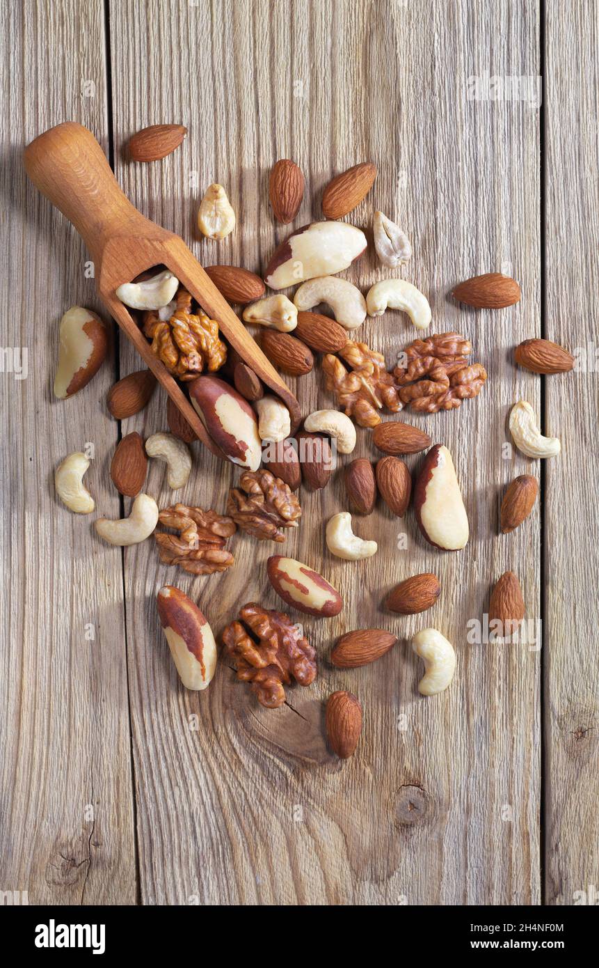 Mixed of nuts in wooden scoop and near on an table, top view. Almond ...
