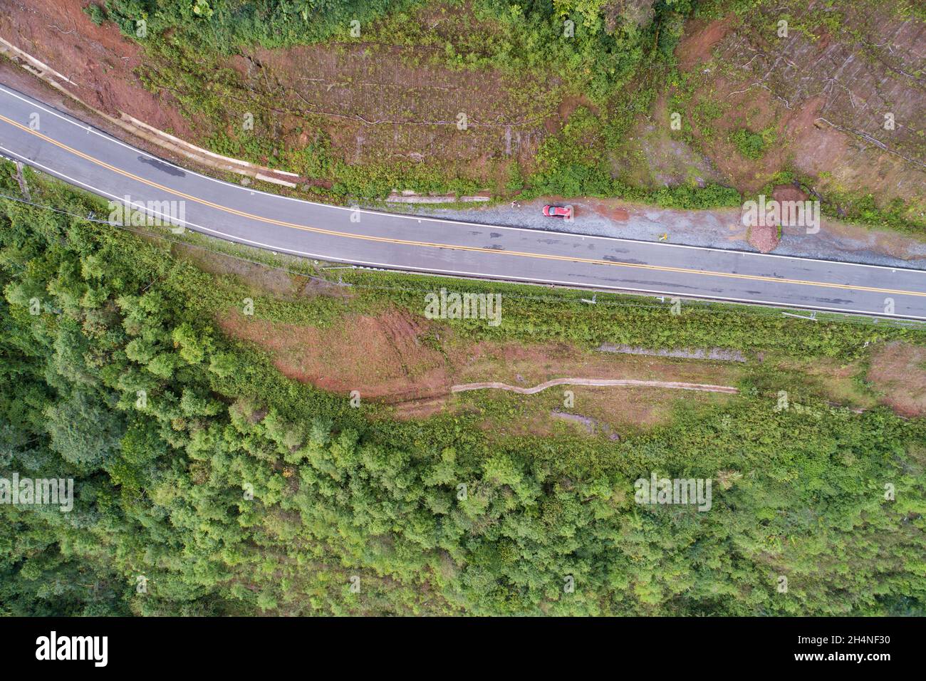 Travel on hilly road in spring aerial view road curve construction up ...