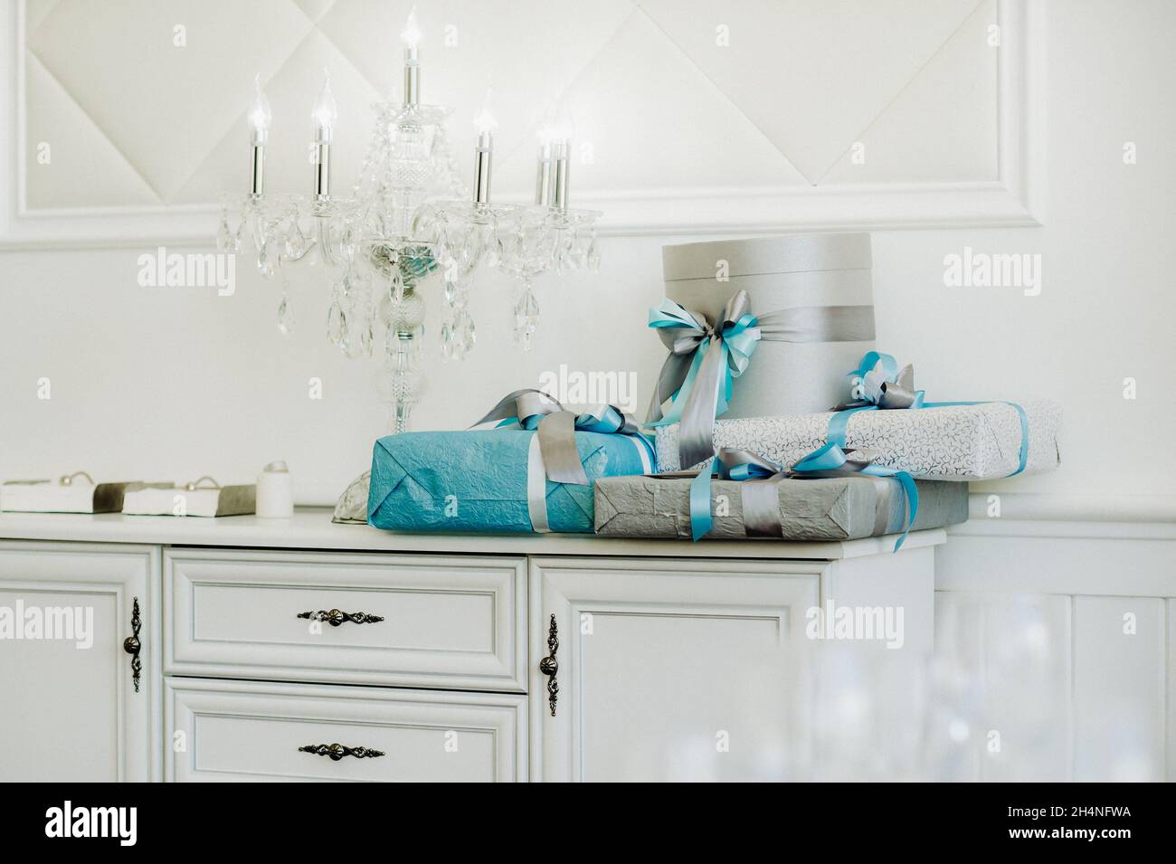 Boxes with gifts Packed in blue and silver paper are on the shelf Stock ...