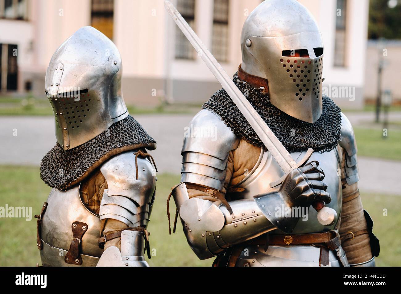 Two knights in armor on the background of a medieval castle.A medieval ...