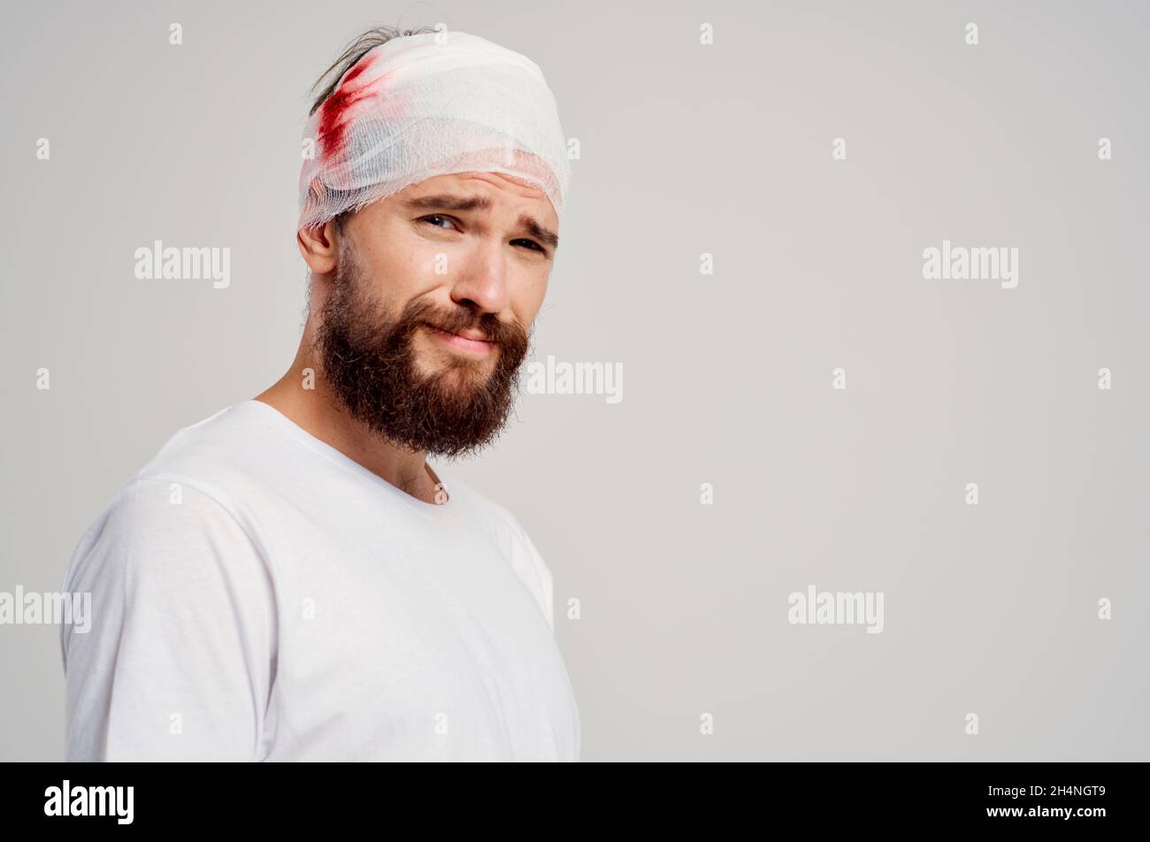 Man bandaged head and hand blood isolated background Stock Photo - Alamy