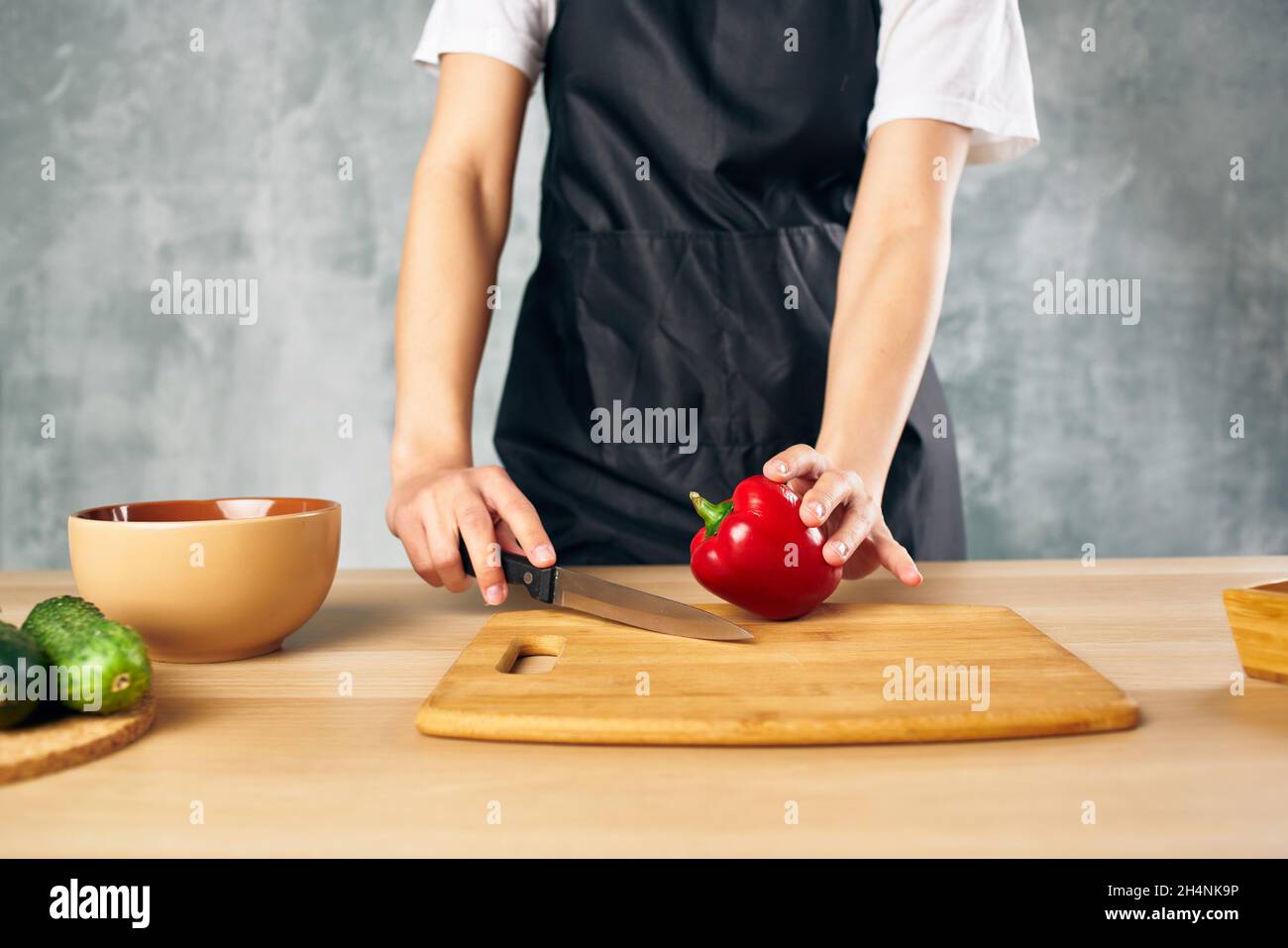 Woman in black apron Cooking healthy eating Stock Photo - Alamy